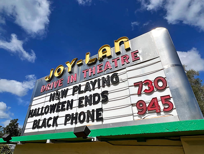 The Joy-Lan's vintage marquee shines bright with its classic red lettering, announcing tonight's double feature to eager movie fans.