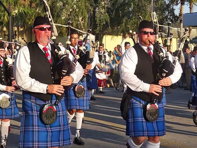 Kilted musicians play traditional bagpipes during the Dunedin Highland Games, continuing the town's proud Scottish traditions.