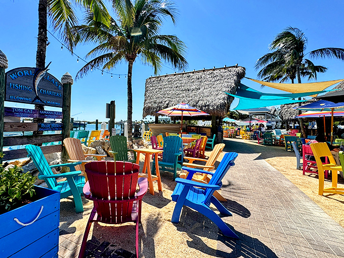 Tiki 52's waterfront setup features rainbow-colored Adirondack chairs perfect for soaking up sunshine and water views.