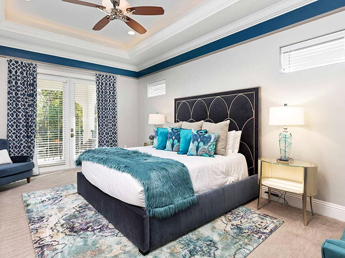 Sweet dreams guaranteed in this serene blue bedroom, where patterned curtains frame windows to a world where you're the main character.
