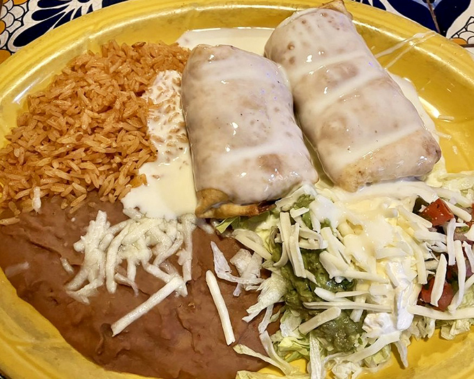 The beef chimichanga plate is what food dreams are made of&mdash;crispy tortilla, seasoned meat, and that river of queso!