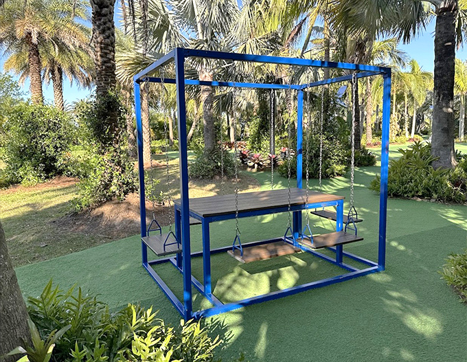 Not your average picnic spot! This blue swing table offers a playful way to relax and soak in the artistic surroundings.