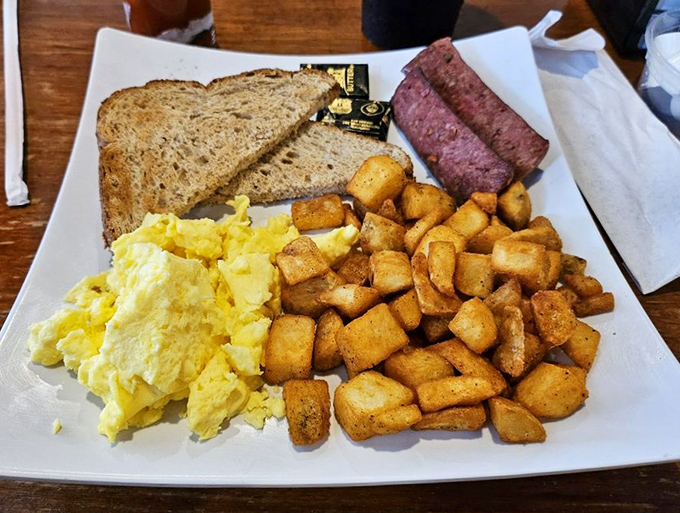 Breakfast done right – fluffy scrambled eggs, crispy potatoes, and savory meat create the foundation for a day of Florida adventures.