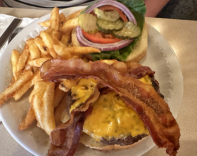 The burger arrives like an old friend &ndash; unpretentious yet impressive, with crispy bacon and melted cheese creating the comfort food trifecta with golden fries.
