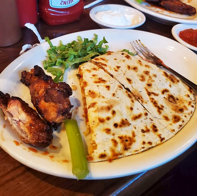 A match made in culinary heaven: smoky wings alongside a cheese-stuffed quesadilla that redefines the lunch combo.