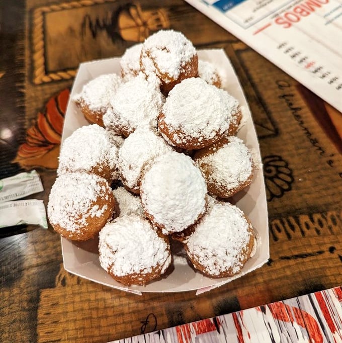 Powdered sugar-dusted corn fritters arrive like little clouds of joy &ndash; crispy outside, fluffy inside, and absolutely irresistible when dipped in honey.
