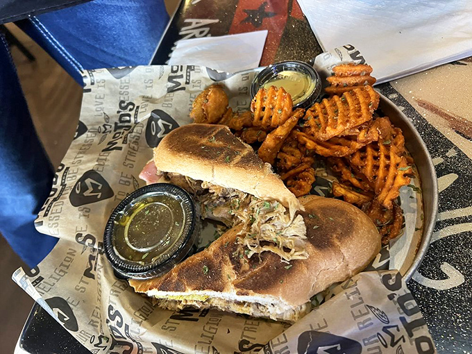 The perfect duet &ndash; a Crazy Cuban sandwich alongside crispy waffle fries. This plate deserves its own standing ovation.