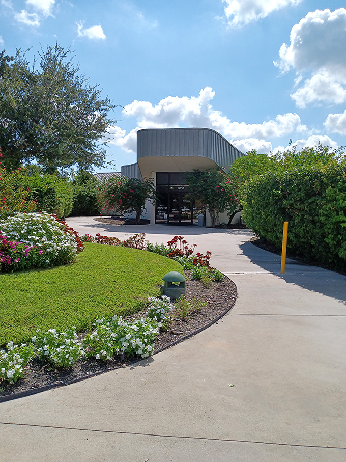 The entrance beckons with manicured gardens and Florida sunshine. Like the botanical equivalent of a red carpet, rolling out for butterfly VIPs.