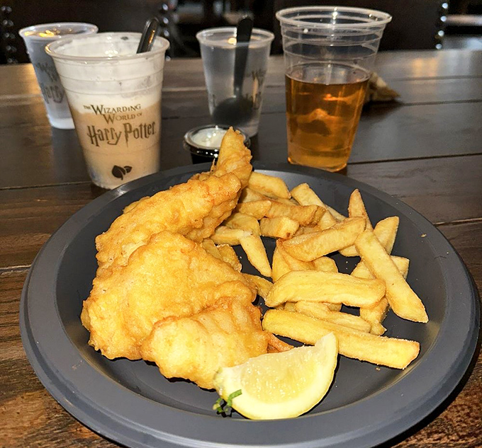 Golden-battered fish with chunky chips &ndash; crispy outside, flaky inside &ndash; served with a lemon wedge for that perfect tangy finish.
