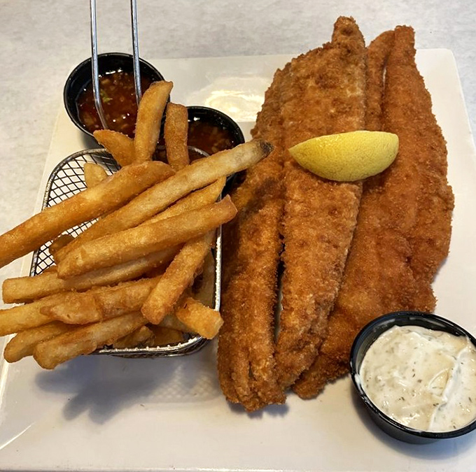 Perfectly fried fish with a golden crust that shatters at first bite, paired with crispy fries and homemade tartar sauce.
