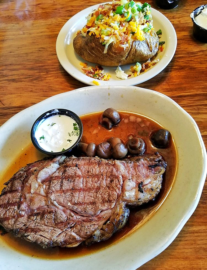 The ultimate power couple: char-grilled prime rib alongside a loaded baked potato that's practically begging to be photographed before devoured.
