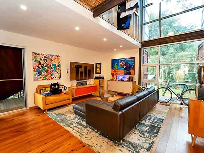 The downstairs living area proves that shipping containers and cozy can coexist, with plush seating and massive windows bringing the outside in.