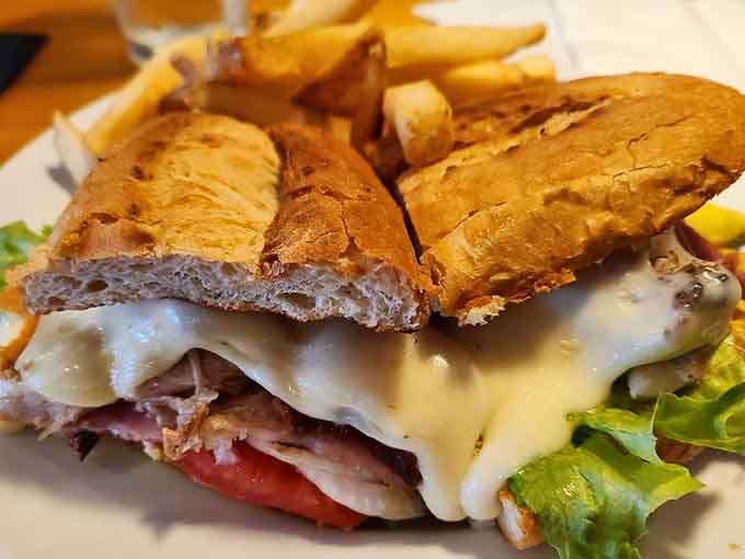 The Cuban sandwich brings its own game, stacked high with ham, pork, and pickles on pressed perfection.