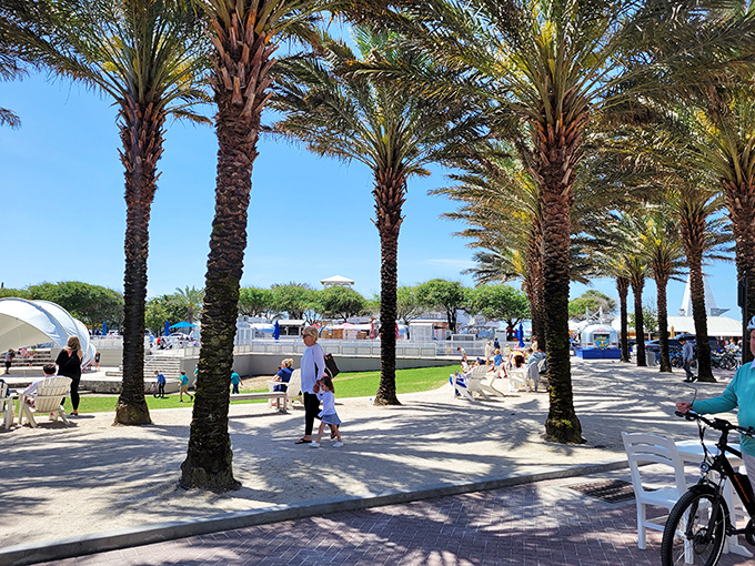 Palm trees create natural corridors through Seaside's community spaces, where families gather and memories are made between beach sessions.