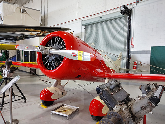 The cherry-red racer looks fast even standing still, its aerodynamic cowling and polished propeller hinting at the speed records these machines chased.