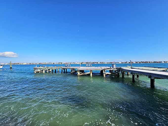 These weathered pilings stand like sentinels guarding the passage between the modern world and a simpler, more beautiful one.