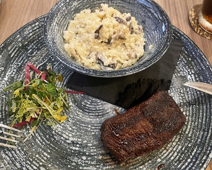 Tender short rib nestles against creamy risotto, creating a plate that's equal parts comfort food and culinary artistry.