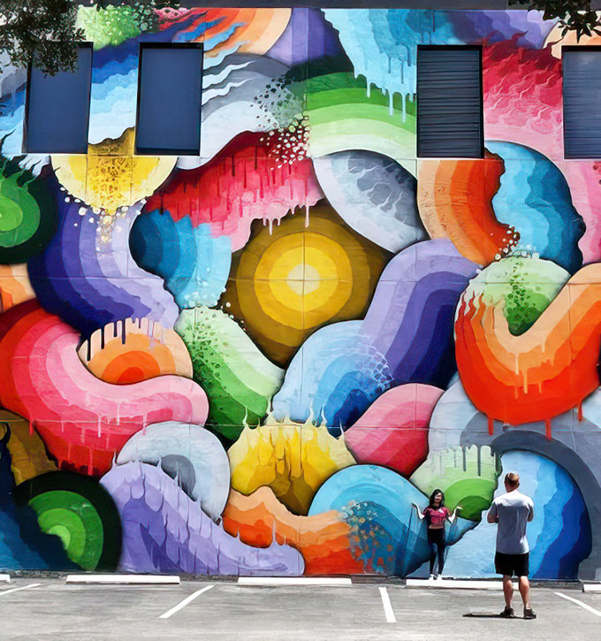 This hypnotic rainbow mural doesn't just catch your eye – it practically grabs it by the collar and refuses to let go.