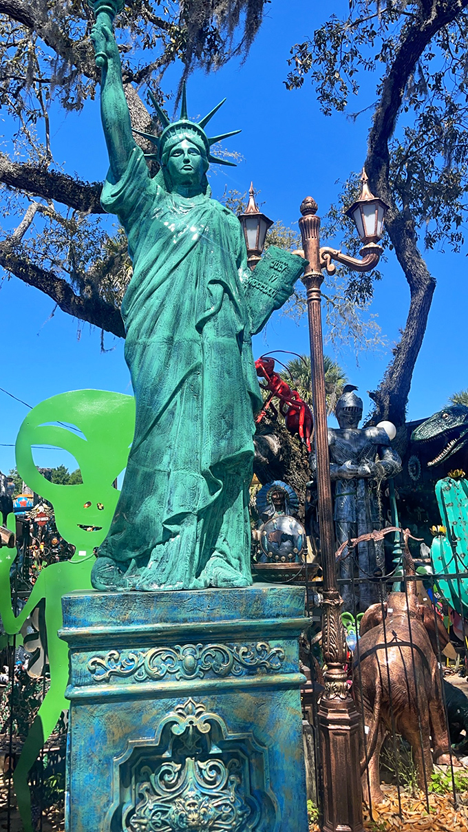 Lady Liberty stands tall among the palm trees, reminding visitors that freedom includes the right to decorate your yard however you please.