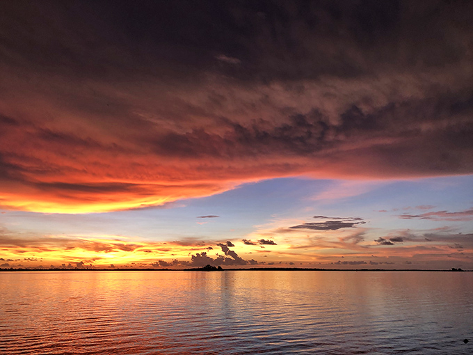 When the sun performs its nightly farewell at Edgewater Park, even smartphone photographers look like National Geographic contributors.