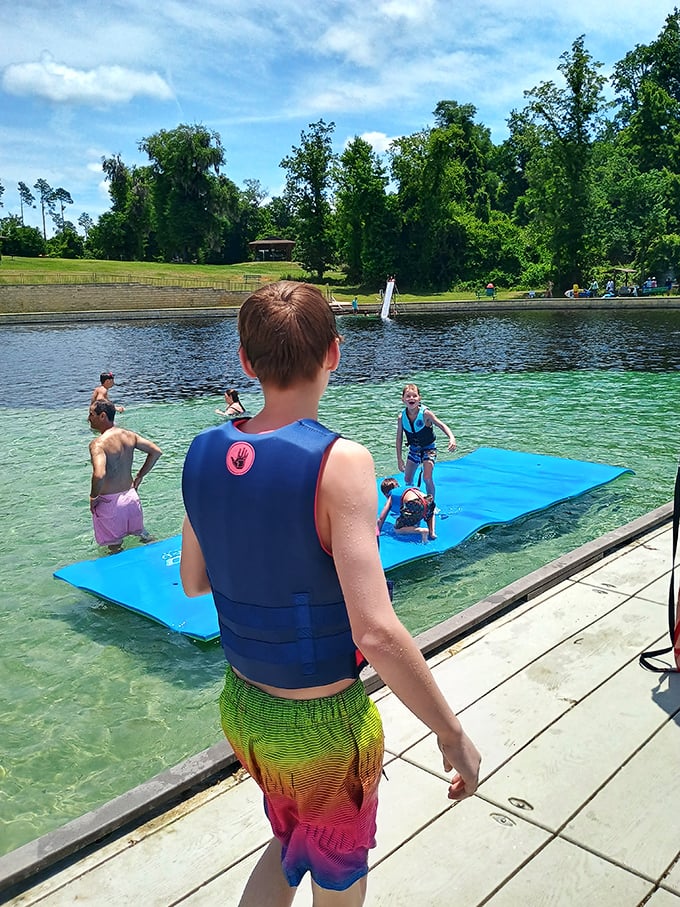 Kids splash on a floating platform while adults pretend they're too mature for such fun &ndash; until no one's looking.