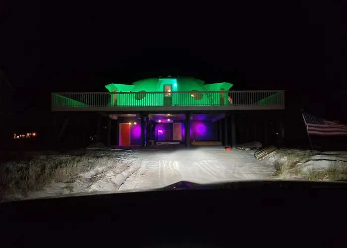 By night, the dome transforms into a glowing beacon, like E.T.'s phone home finally got through with spectacular results.