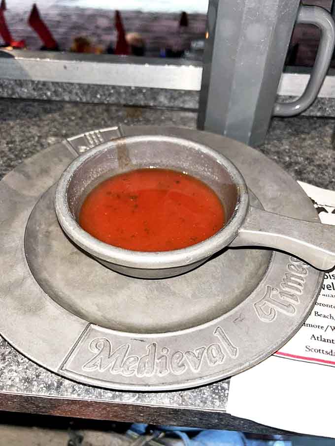 Tomato bisque served in a metal bowl &ndash; civilization's compromise between authentic medieval dining and not wanting to spill soup all over your tunic.