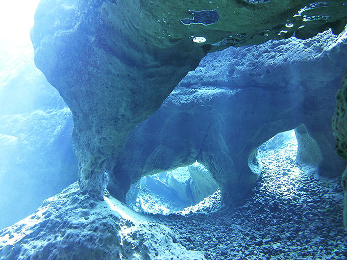 Limestone formations create an alien landscape beneath the surface, sculpted over millennia into shapes that would make any modern artist hang up their tools in defeat.