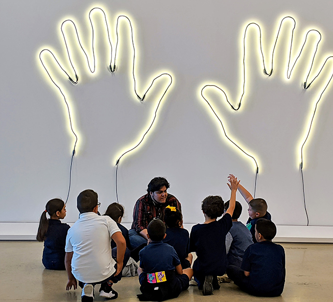 Young minds engage with illuminated art, proving that appreciation for creativity starts early when museums make magic accessible to all ages.