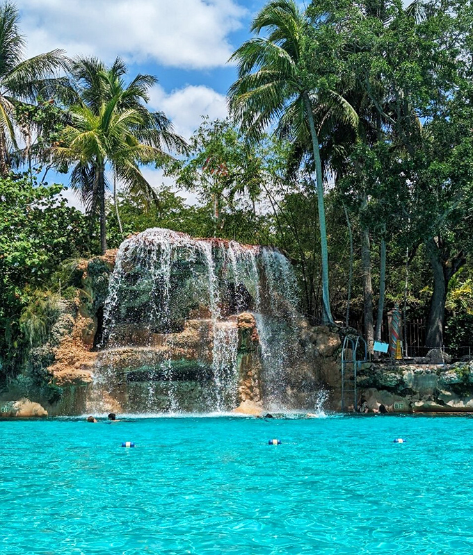 Nature meets architecture in perfect harmony as the waterfall cascades down ancient coral rock, creating both visual splendor and soothing ambient sounds.