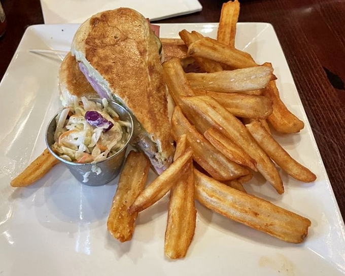A symphony of flavors pressed between authentic Cuban bread, served with hand-cut fries that are crispy on the outside, fluffy within.