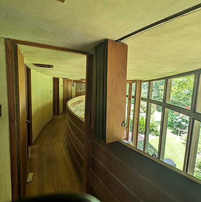 The curved balcony follows Wright's hemicycle design, creating spaces that flow like water – no harsh corners to interrupt life's natural rhythm.