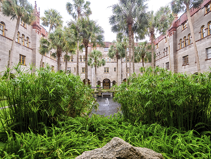 Tropical plants frame the courtyard's elegant architecture, creating a perfect marriage of natural beauty and human craftsmanship that evolves with each season.