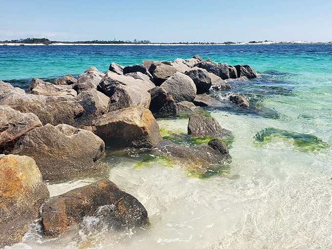 Massive rocks create natural aquariums where curious fish dart between shadows, offering snorkelers a front-row seat to underwater neighborhoods.