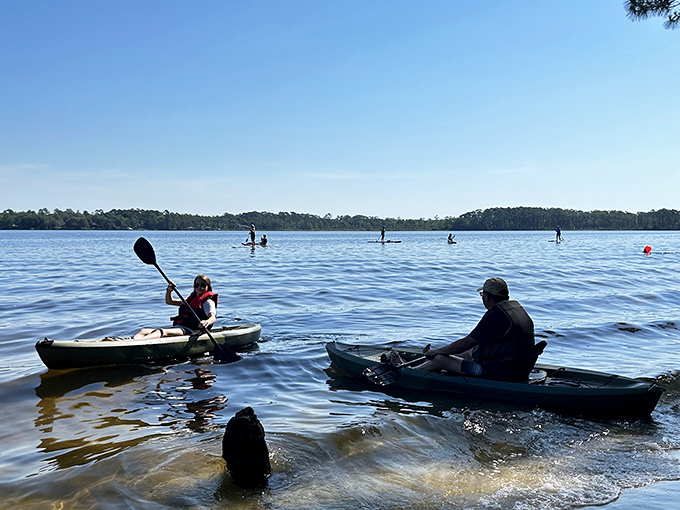Paddle your worries away on Rocky Bayou's crystal waters, where kayakers find serenity between strokes.