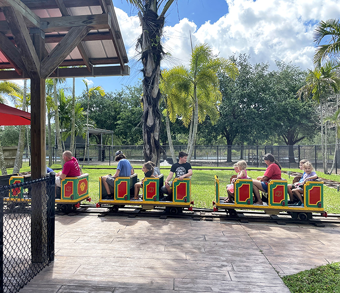 All aboard the safari express! Young adventurers embark on a train ride through the park's lush landscape.