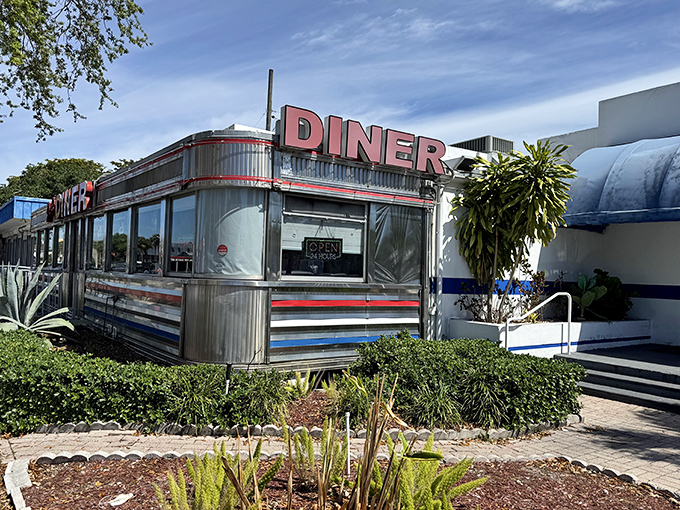 The polished metal exterior of Jack's Hollywood Diner reflects Florida's sunshine, a shining example of authentic 1950s diner architecture.