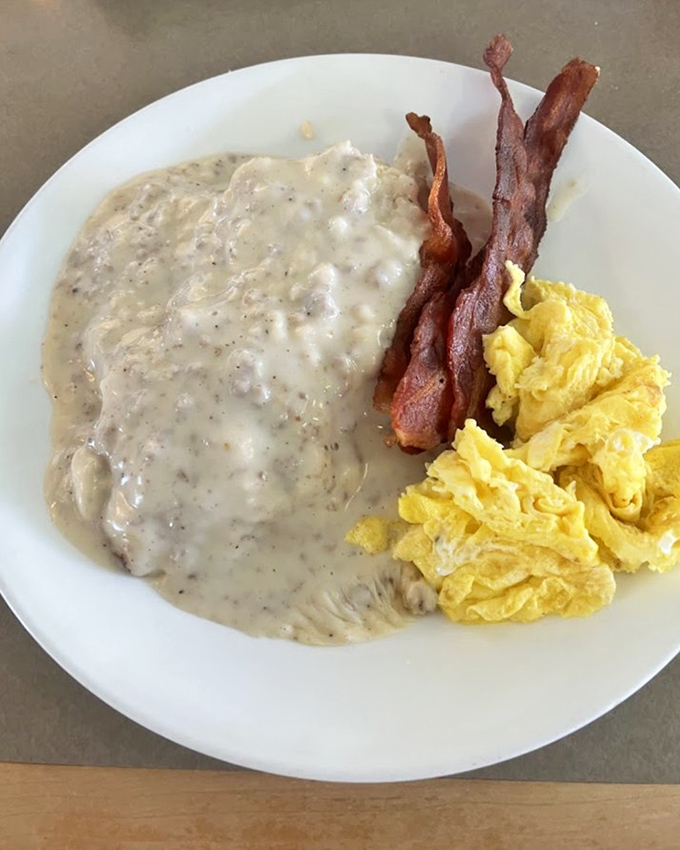 Biscuits and gravy: the breakfast that hugs you from the inside. Paired with crispy bacon and fluffy eggs for maximum comfort.