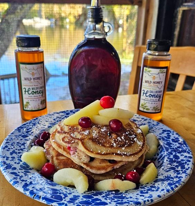 Seasonal cranberry apple pancakes garnished with fresh fruit – nature's candy atop pillowy pancake perfection.