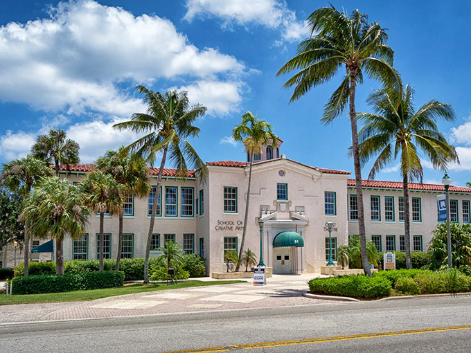The historic Crest Theatre glows with string lights, its palm sentinels wrapped in colorful art installations that blend history with whimsy.
