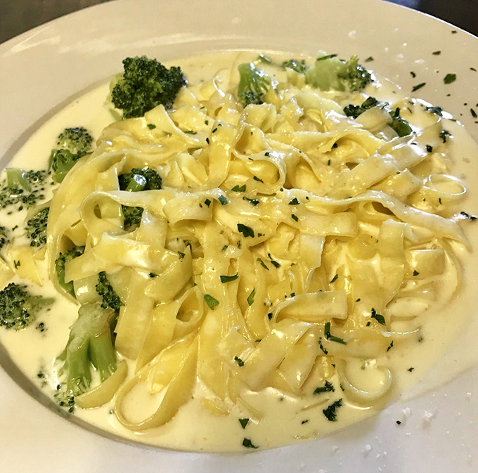 Even vegetables become irresistible when bathed in DiPiazza's legendary Alfredo sauce &ndash; bright broccoli florets adding color and crunch to silky fettuccine.