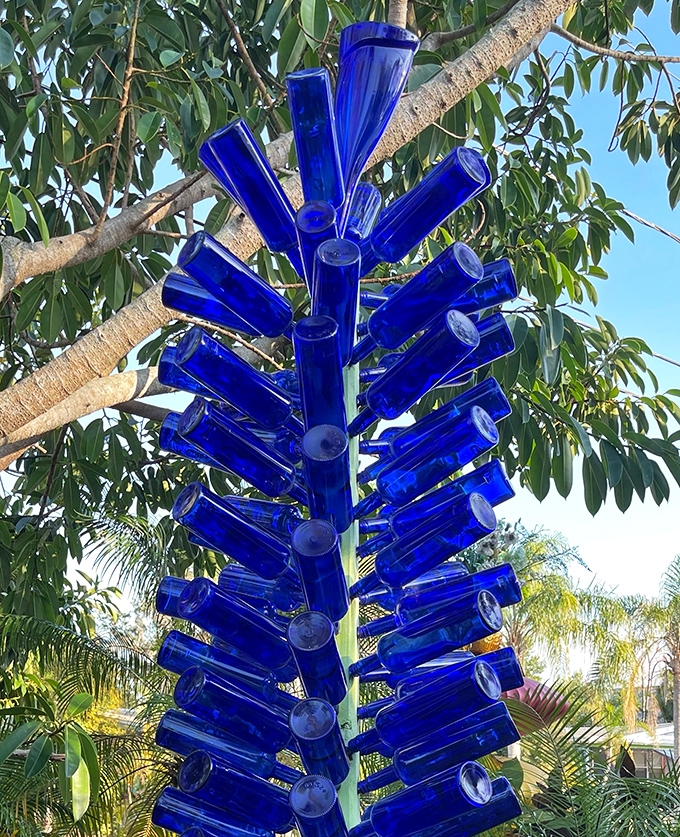 Blue bottle trees transform ordinary foliage into sparkling azure sculptures &ndash; proving that sometimes, trees just need a little extra pizzazz.