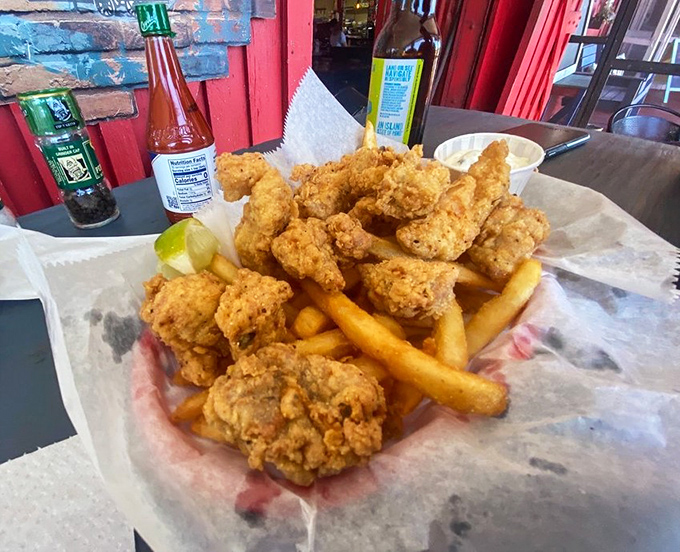 Perfectly fried gator tail rests atop golden fries &ndash; a simple presentation that lets the quality of ingredients shine through.