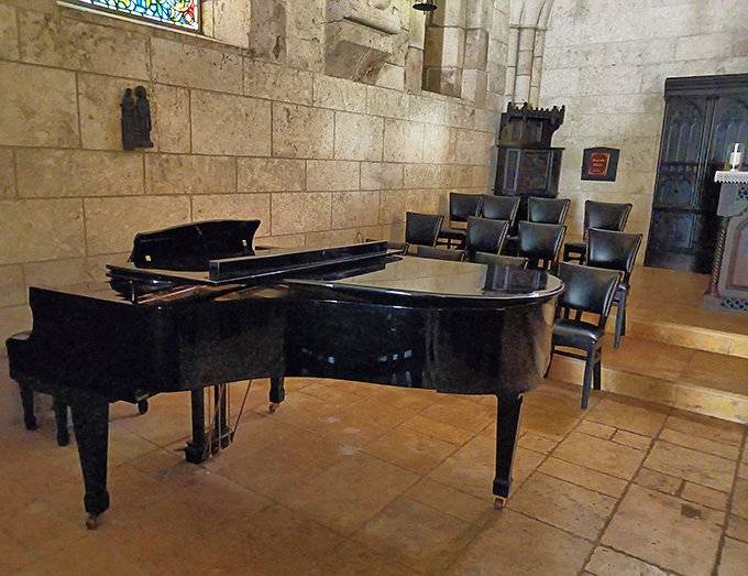 Musical conversations across centuries happen here, where polished ebony meets weathered stone in perfect acoustic harmony.