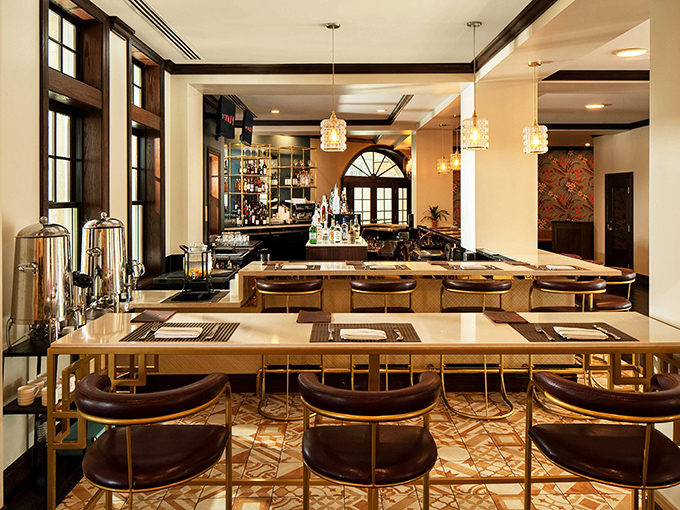 HEW Parlor & Chophouse's elegant bar area combines warm woods and sophisticated lighting, perfect for pre-dinner cocktails.