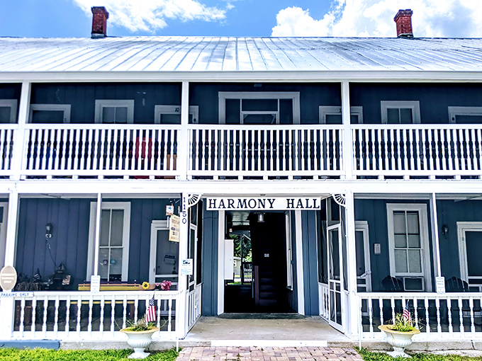 Harmony Hall stands as a gathering place for the community, its welcoming blue exterior and white porch inviting visitors to pause and connect.