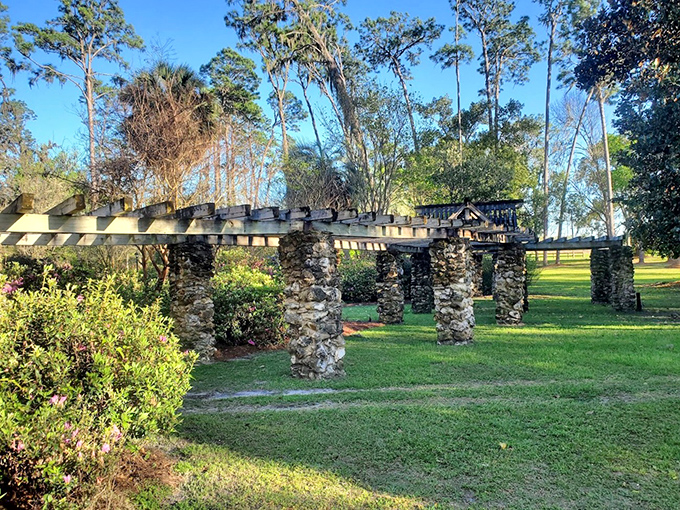 Stone columns stand as silent witnesses to history in Heritage Park, where architectural remnants create a peaceful garden sanctuary.