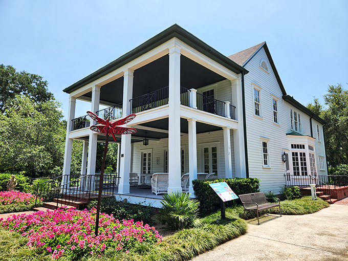 The Historic Leu House Museum stands as a graceful time capsule, its white facade gleaming against the lush landscape.