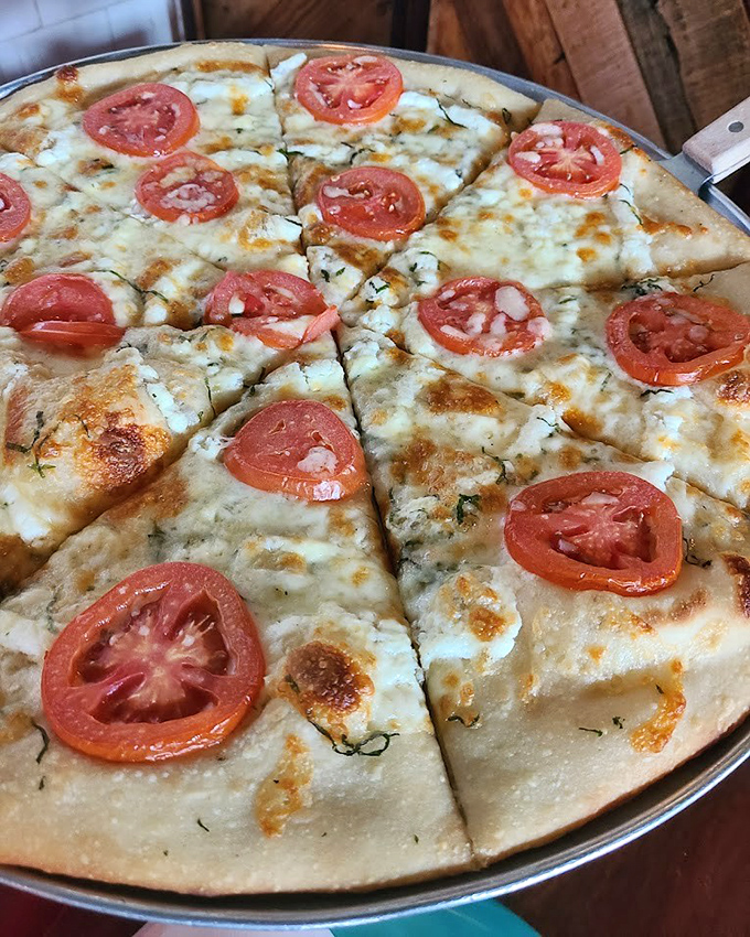 The La Bianco showcases the beauty of simplicity &ndash; fresh tomatoes dancing atop a canvas of melted cheese and aromatic herbs.