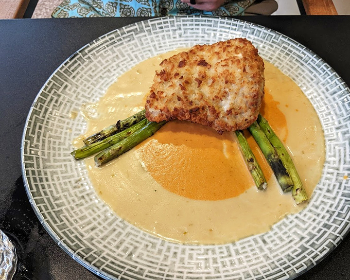 Ocean meets orchard in this stunning dish where macadamia-crusted fish bathes in a sauce worth sipping with a spoon.